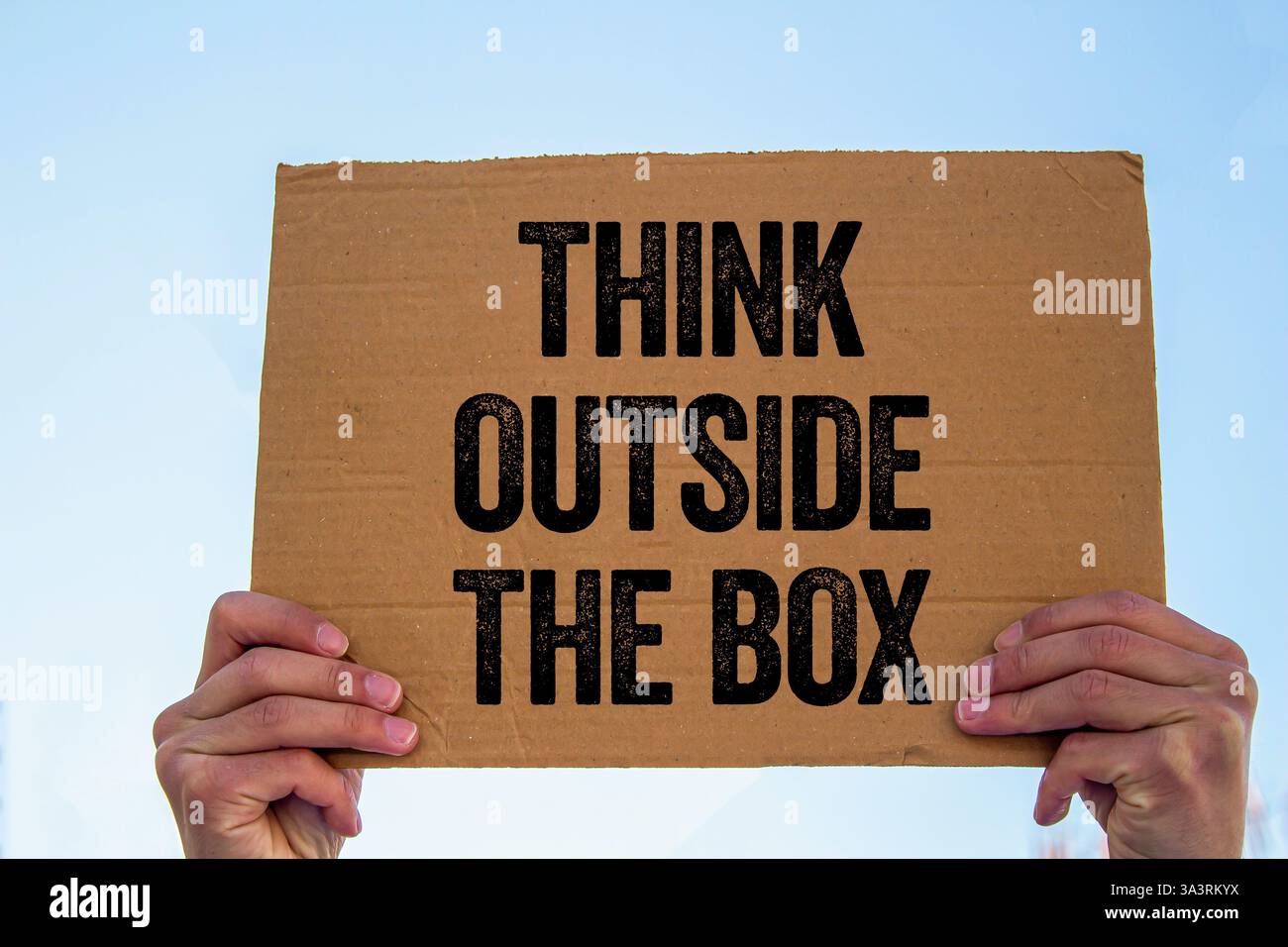 Think outside the box message written on cardboard sign. Conceptual ...