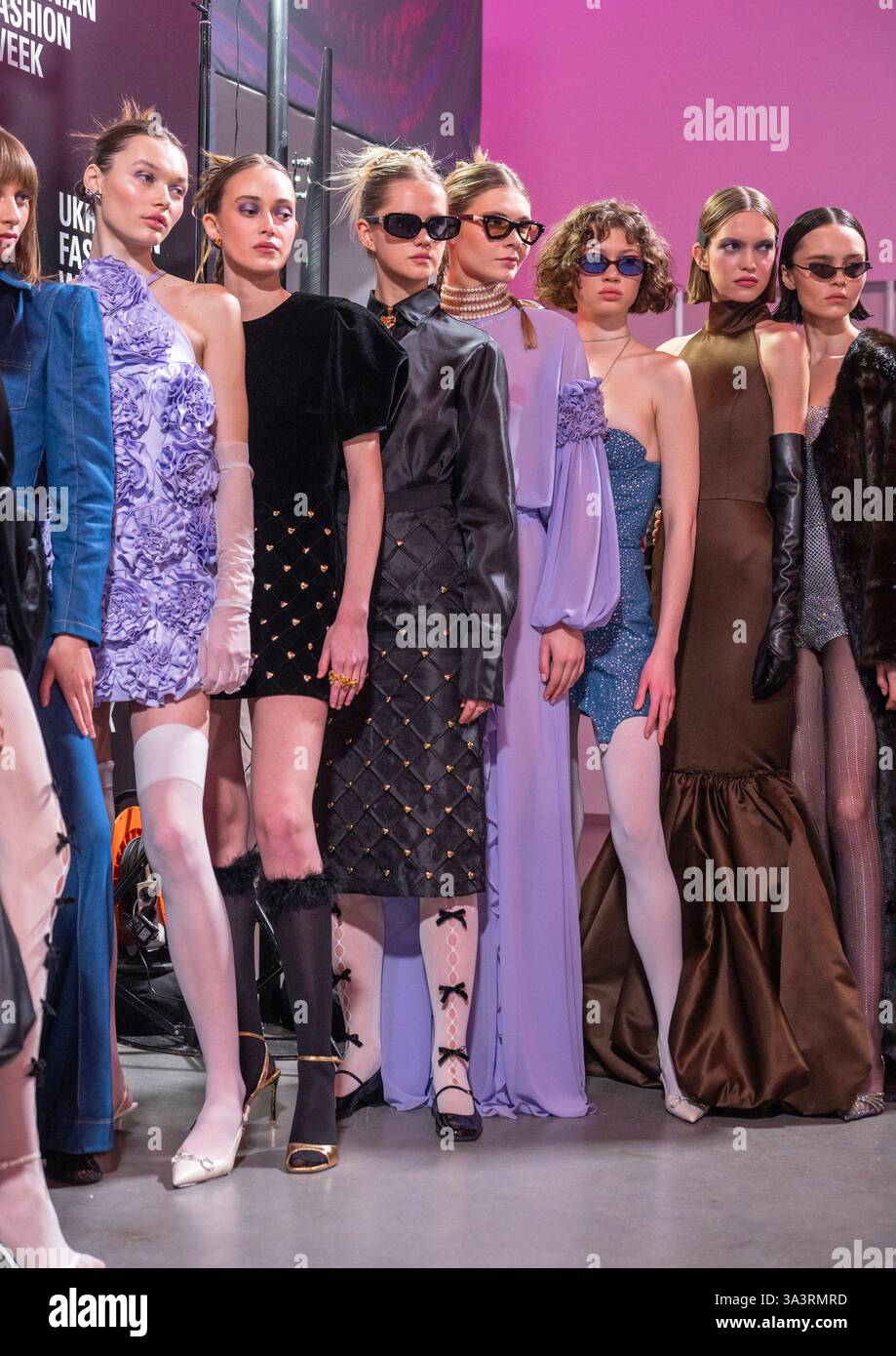 Models gather and prepare for the runway at GURANDA, showcasing the ...