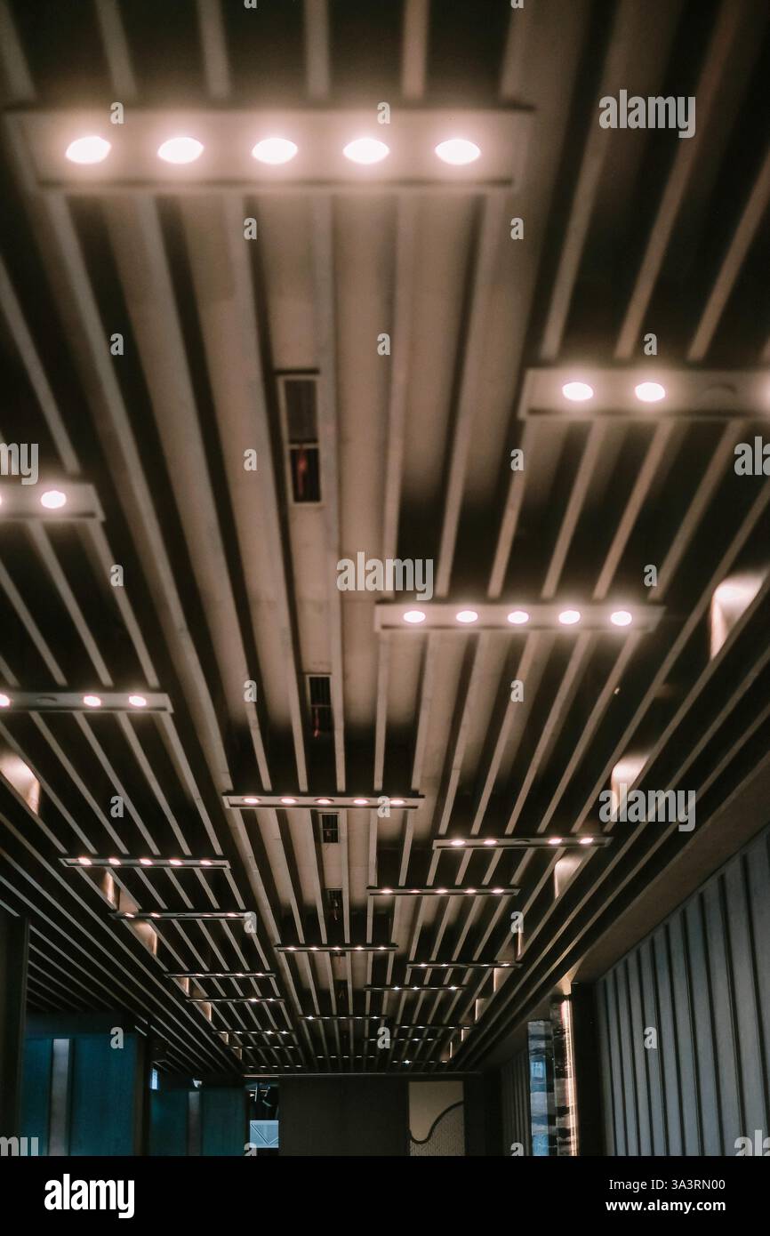 A modern architectural ceiling design featuring a rhythmic arrangement ...
