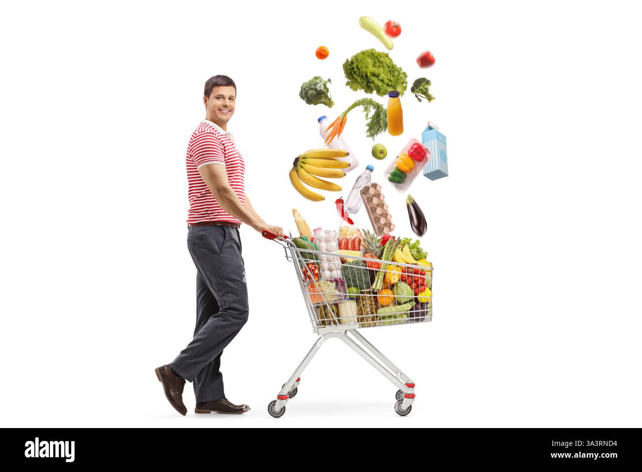 Man collecting falling food products with a shopping cart and smiling ...
