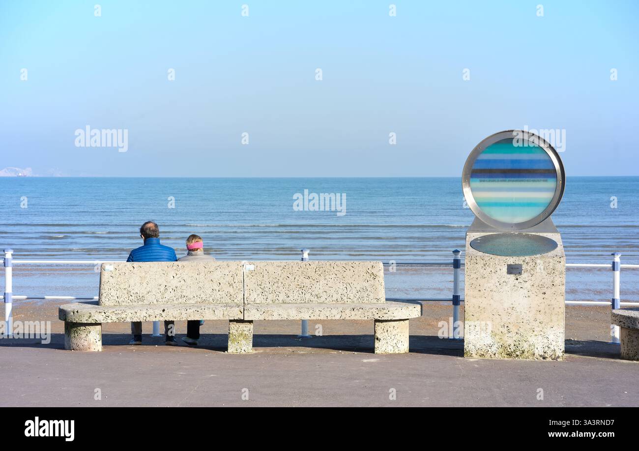 A couple sit on the stone bench by a sculpture (The levels by Raphael ...
