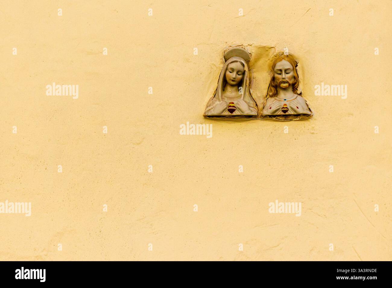 Sculptures Depicting Religious Figures Embedded on a Stucco Exterior ...