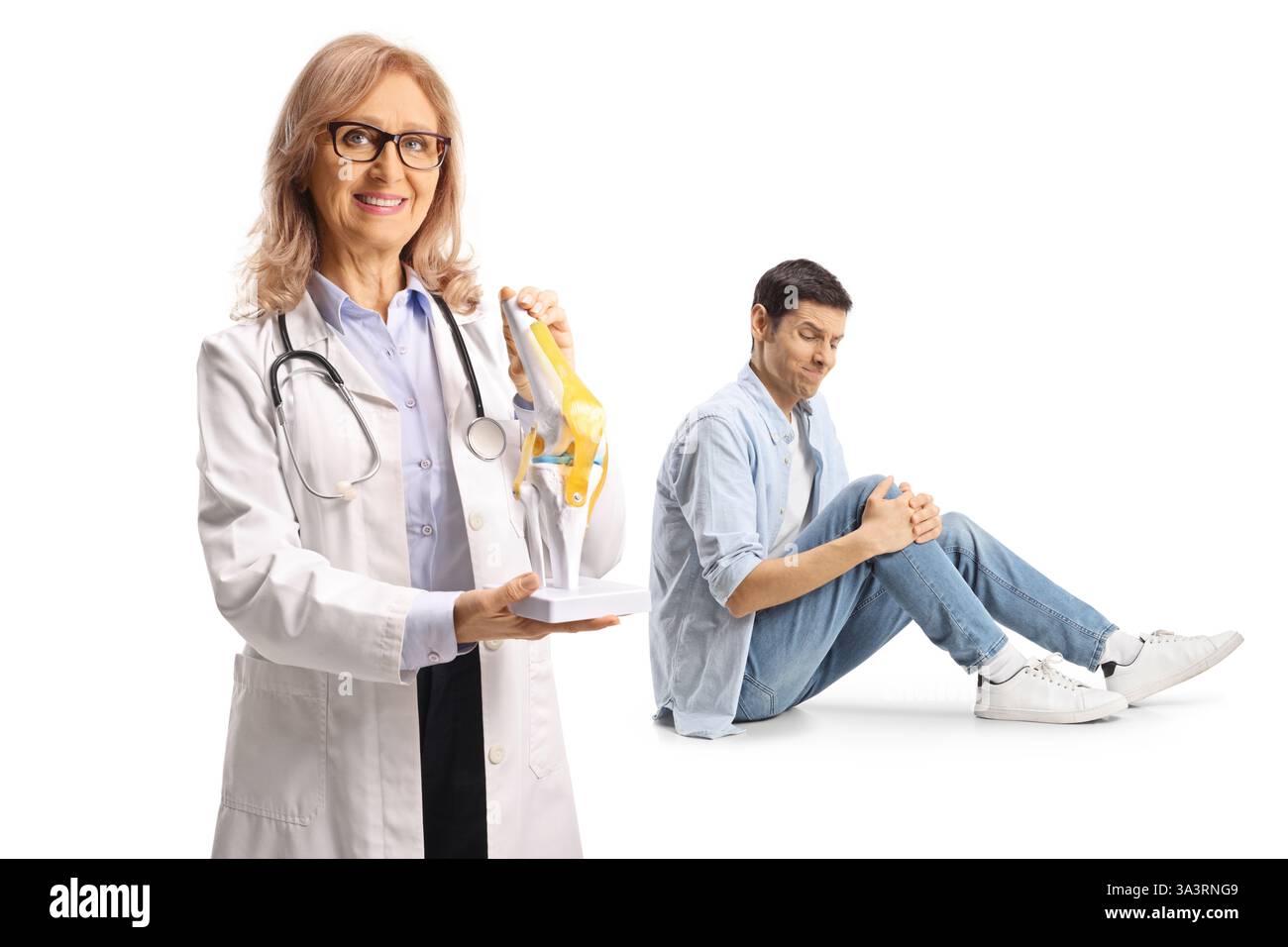 Female doctor holding a knee bone model and young man suffering from ...