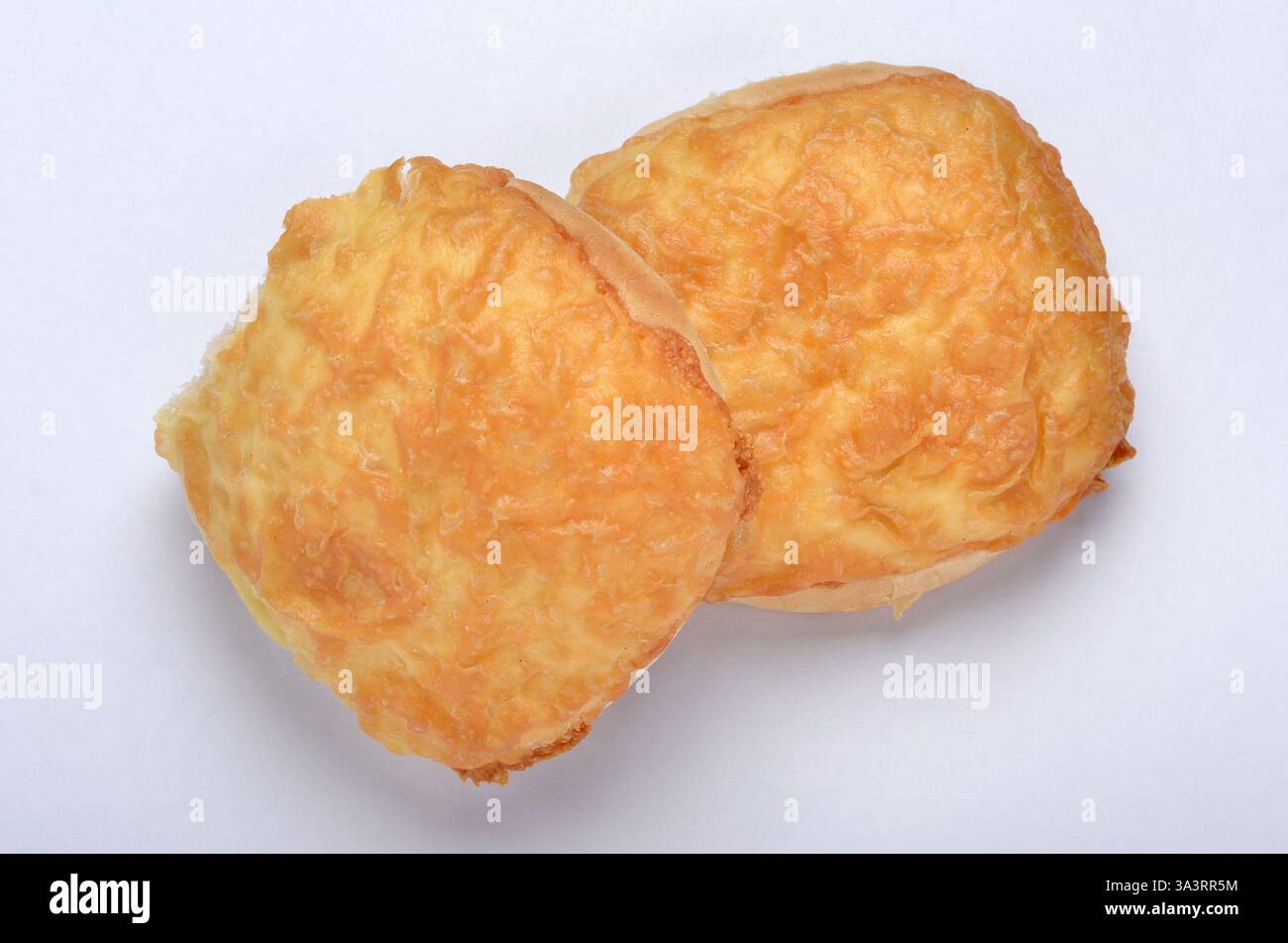 Two cheese topped baked bread rolls top view on white background Stock ...