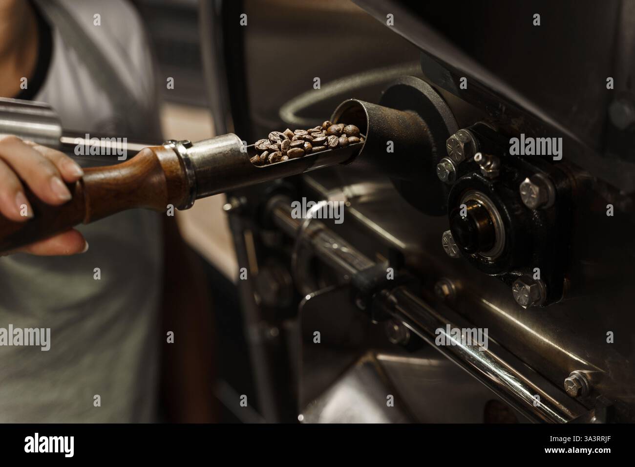 Roasting coffee beans process in coffee machine in the production. Fried coffee grains in the ...