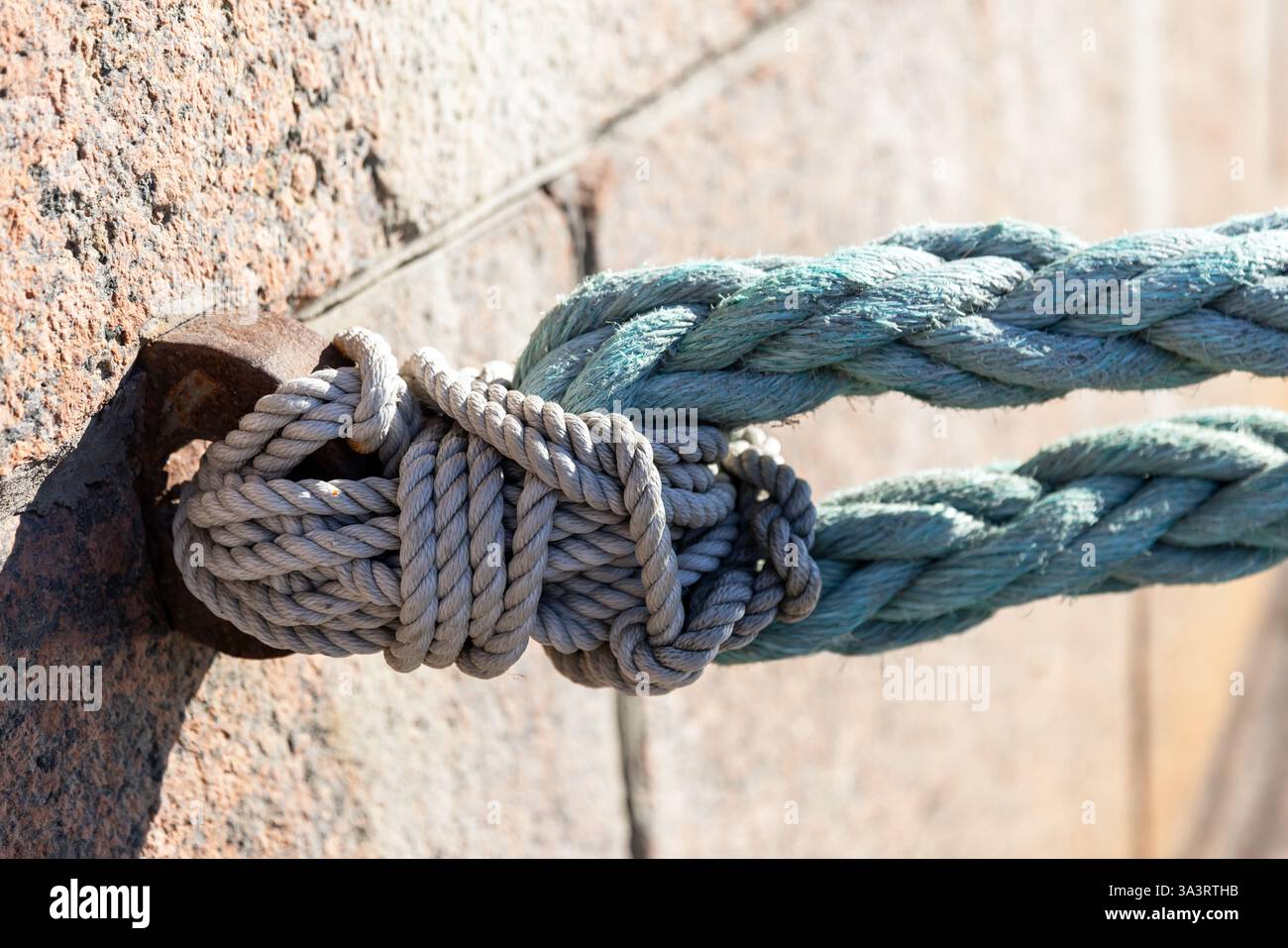 Detailed close-up photo of a securely tied nautical rope knot attached ...
