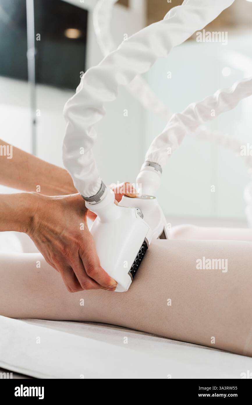 Young woman is having lymphatic drainage treatment to remove leg ...