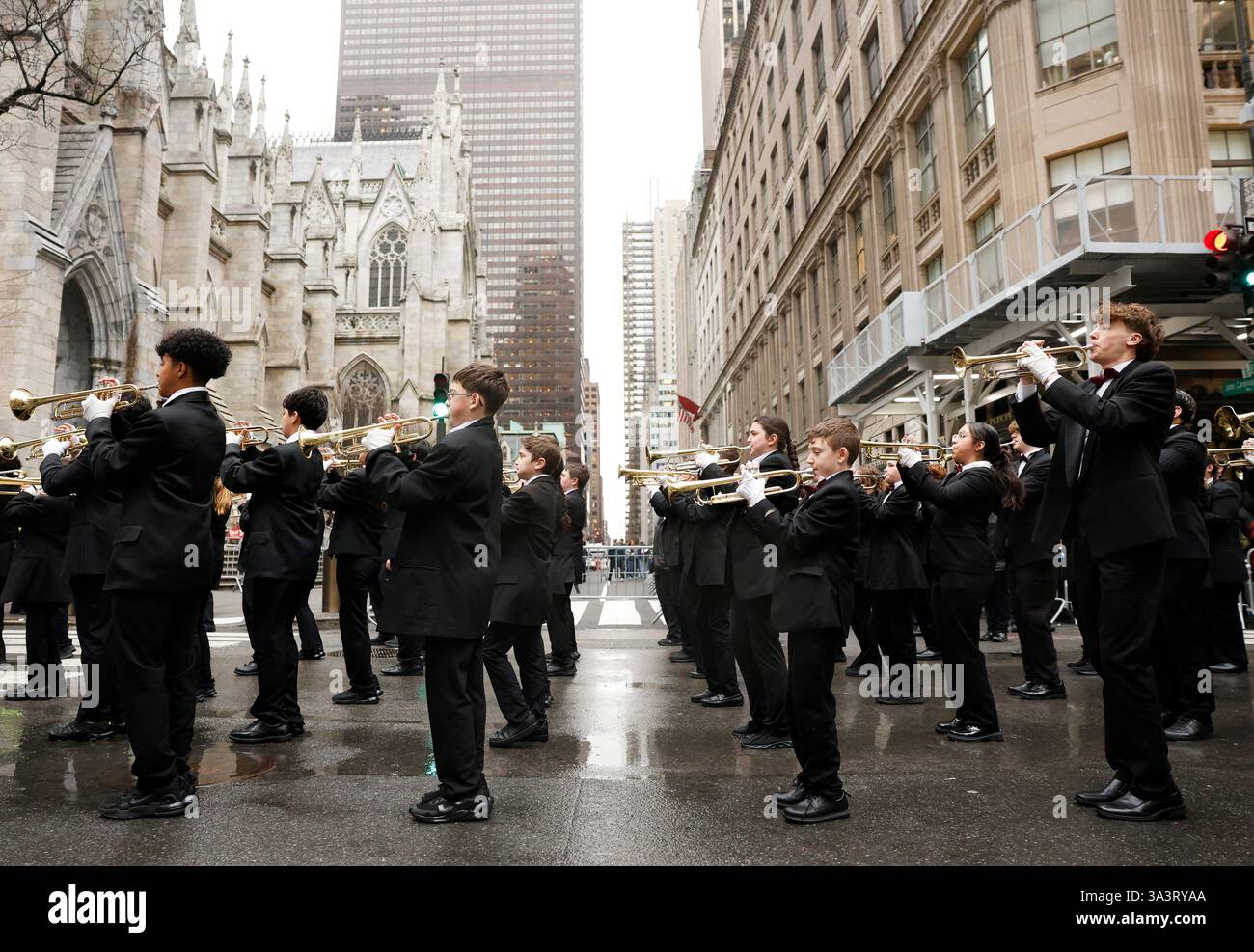 New York, United States. 17th Mar, 2025. A marching band marches past ...