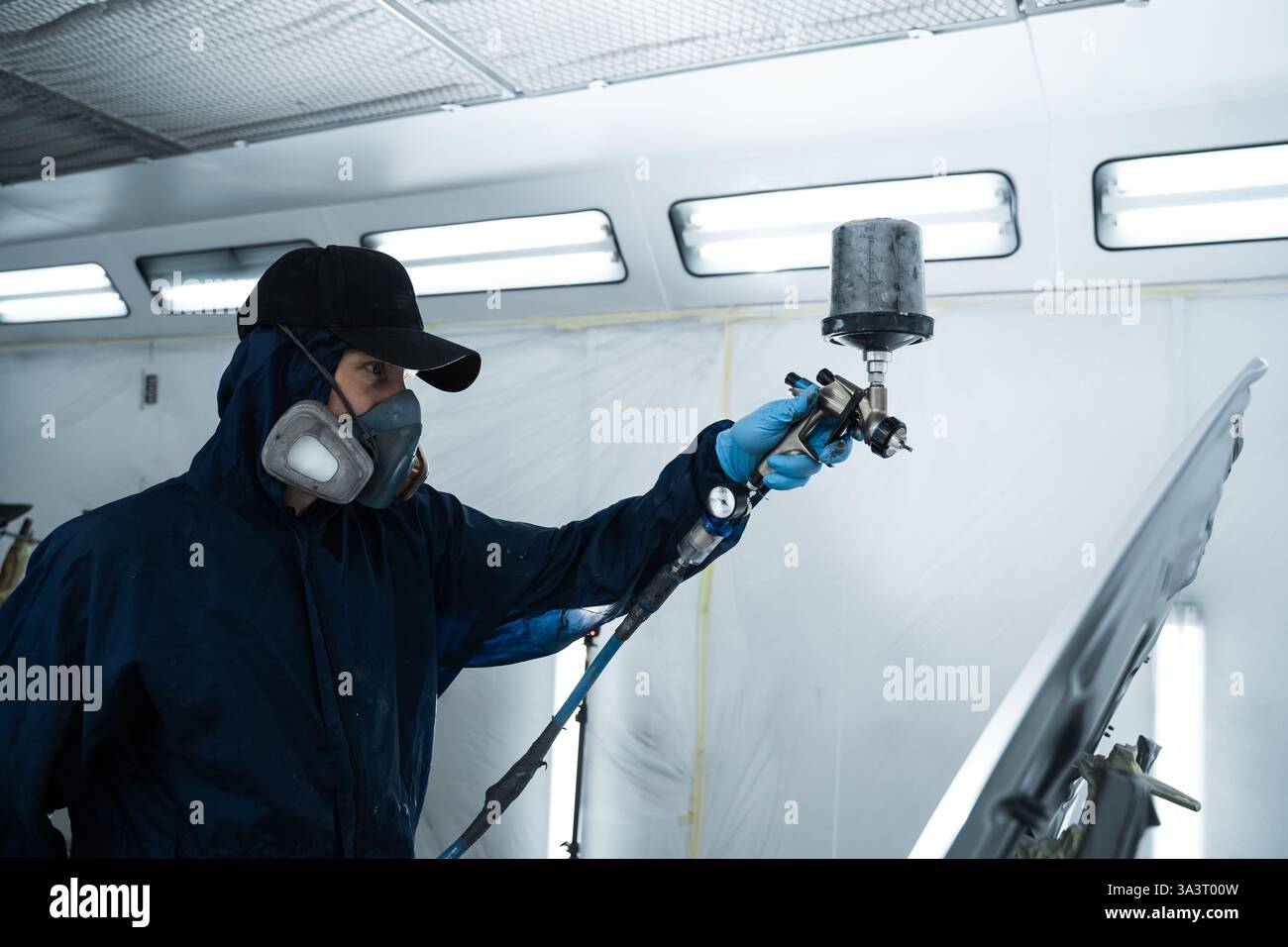 Mechanic from vehicle maintenance service is spreading paint on car ...
