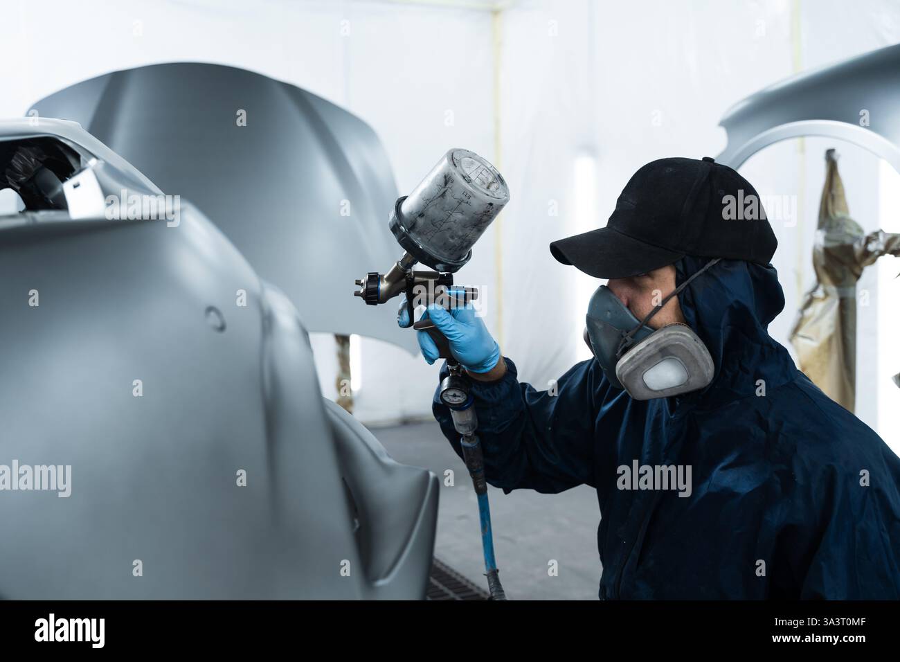 Mechanic from vehicle maintenance service is spreading paint on car ...
