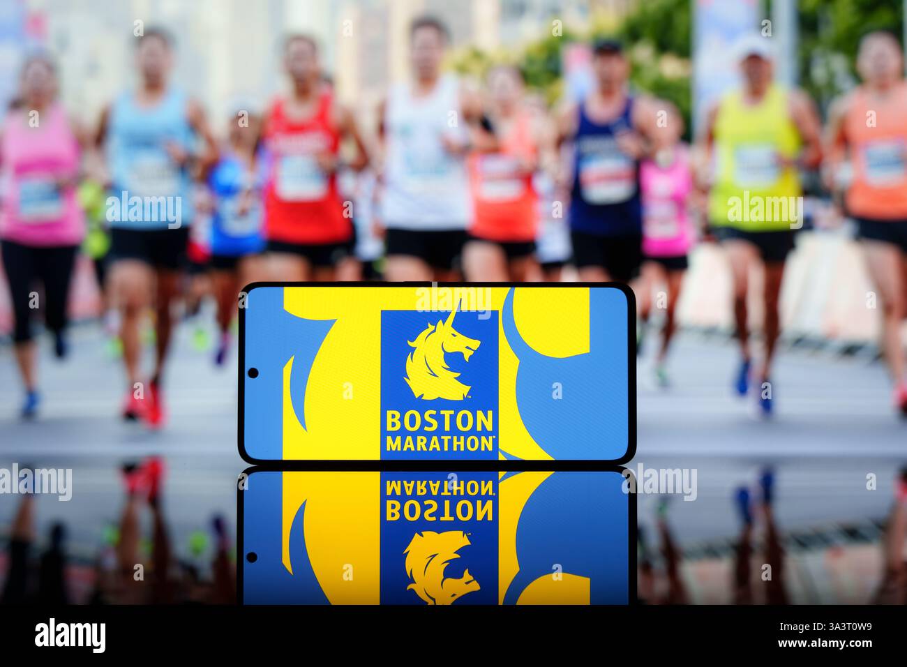 Smartphone displaying Boston Marathon logo with blurred runners in the ...