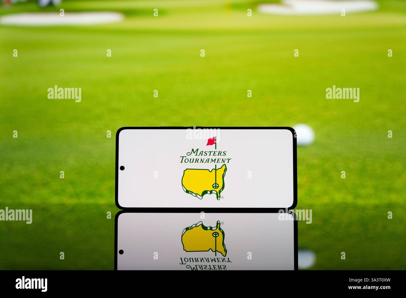 Smartphone displaying Masters Tournament logo with a blurred golf ball ...