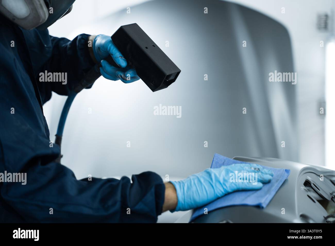 Mechanic is working with anti static gun to neutralize static ...