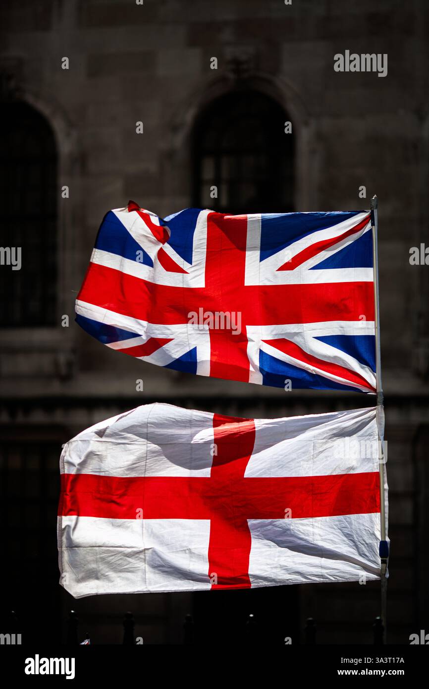 Union Jack and Saint George's Cross flags displayed outdoors against a ...