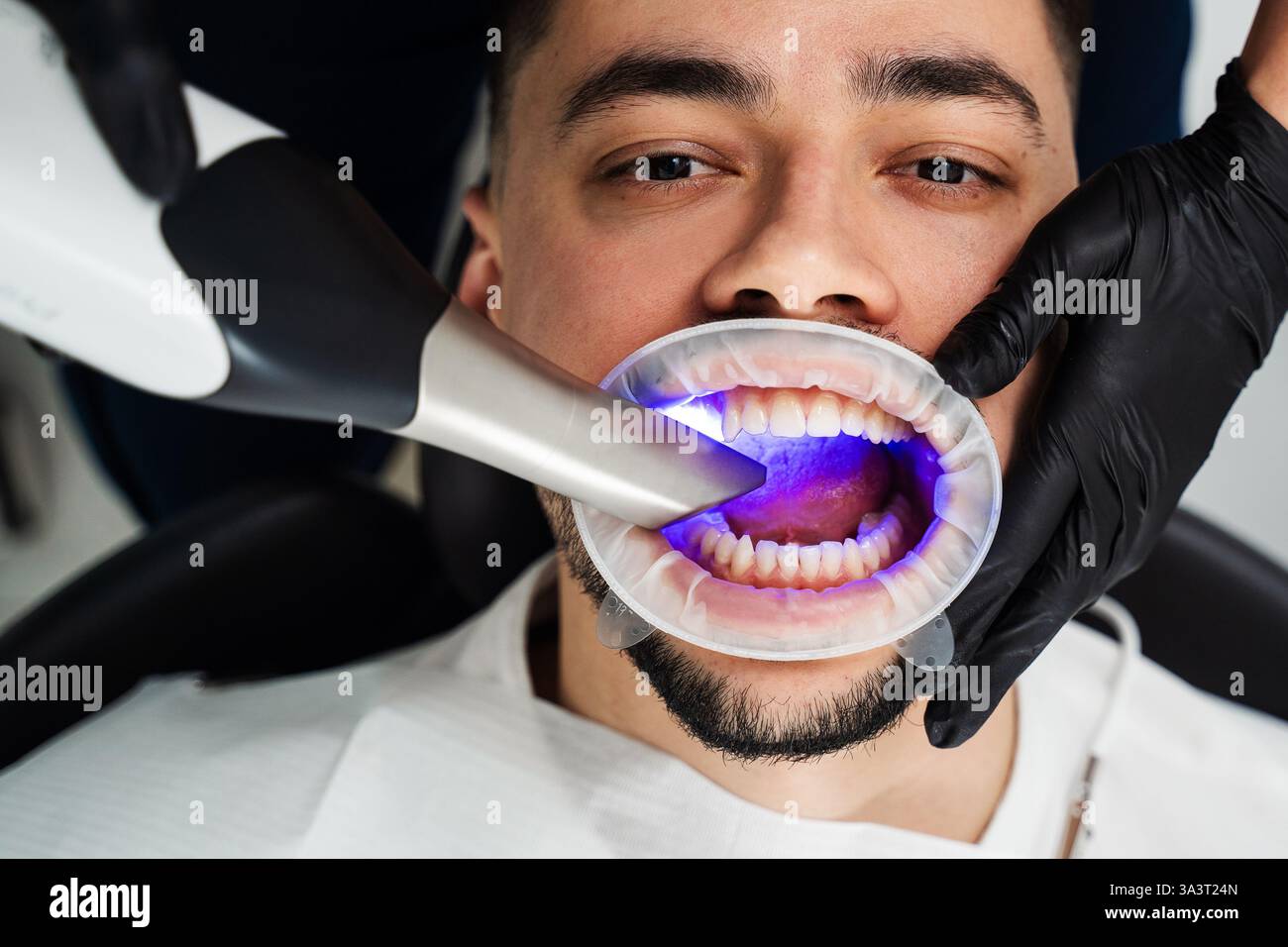 Doctor examines teeth of patient with x-ray scanning equipment. Dental ...