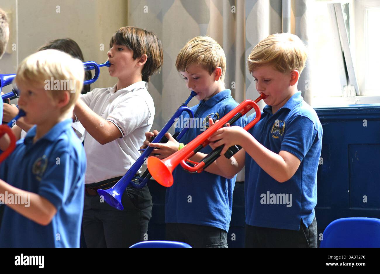 School music pupils playing plastic trumpets at primary school, Britain ...