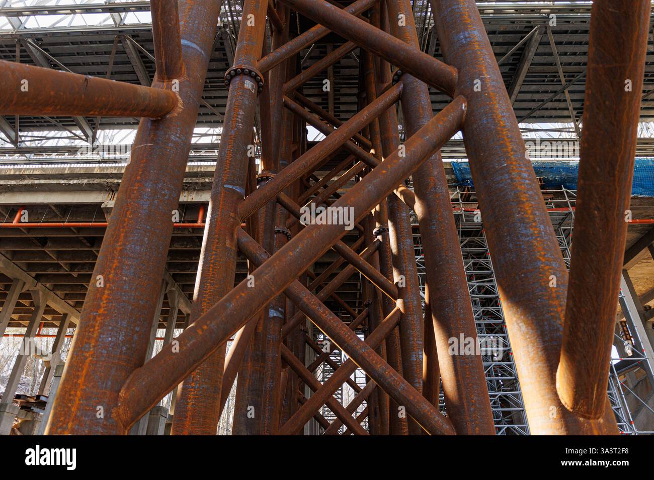 Rusty metal beams and scaffolding supporting a bridge under ...