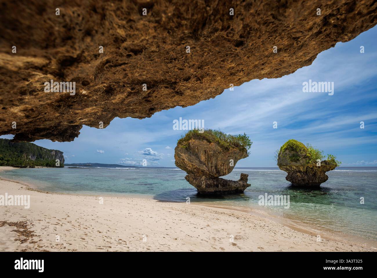 A view of the clear warm waters and mushroom rocks at Hilaan Beach ...