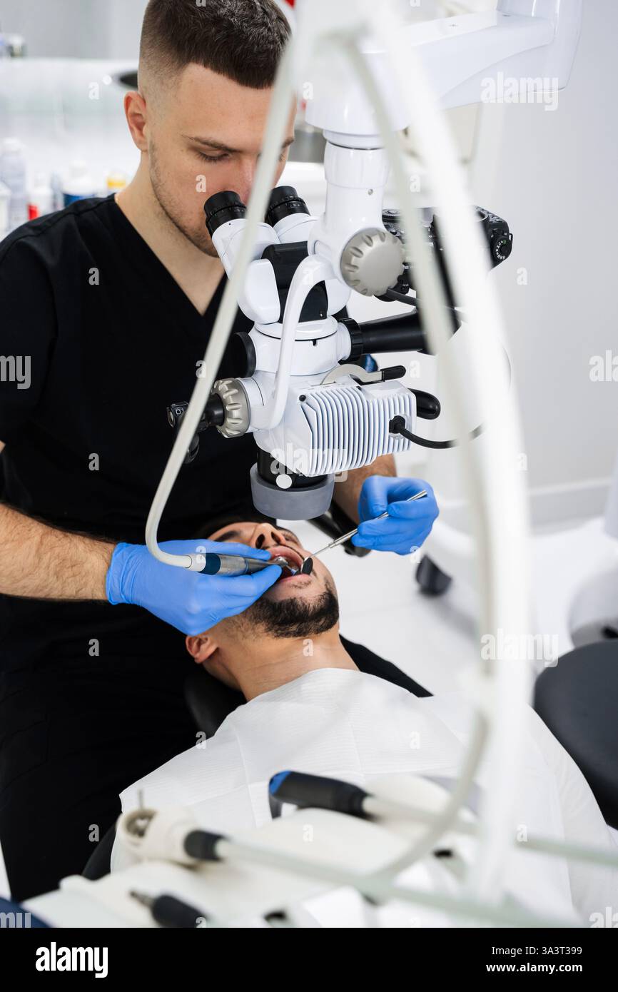 Dentist uses operating microscope to polish teeth of the patient ...