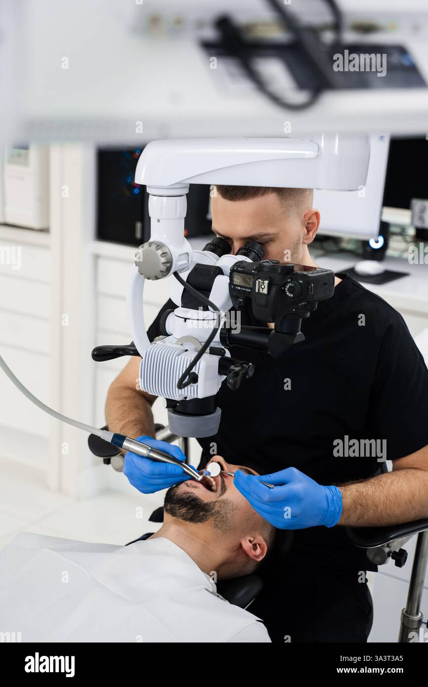 Dentist uses operating microscope to polish teeth of the patient ...