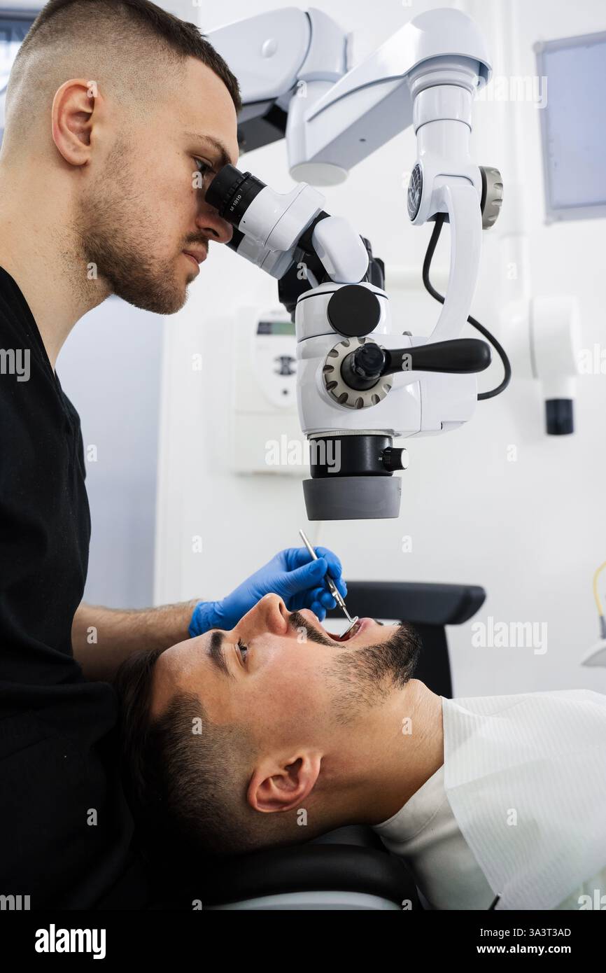 Dentist uses operating microscope to polish teeth of the patient ...