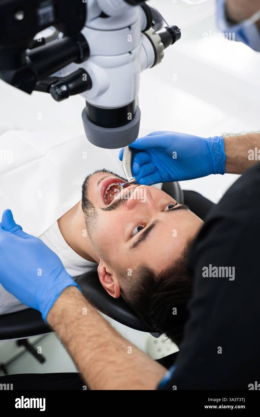 Dentist uses dental polisher hardware and mirror to whiten teeth of the ...
