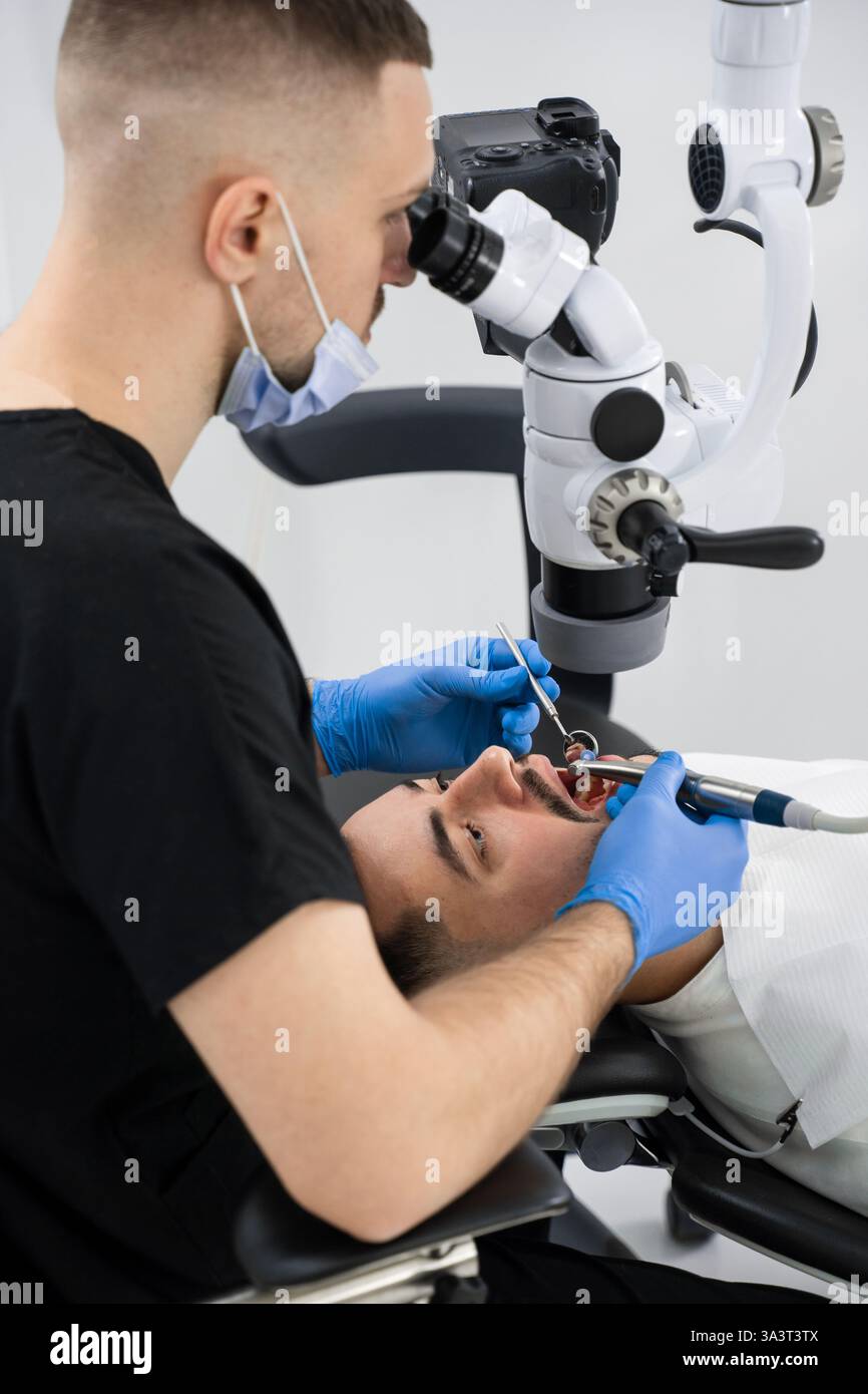 Digital microscope diagnostic by dentist. Polishing teeth with digital ...