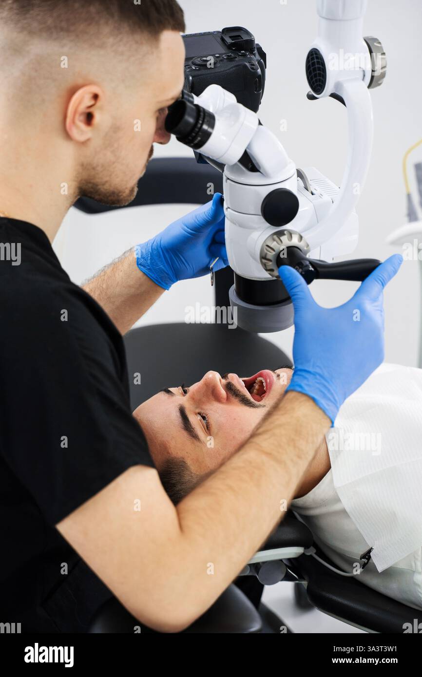 Digital microscope diagnostic by dentist. Polishing teeth with digital ...