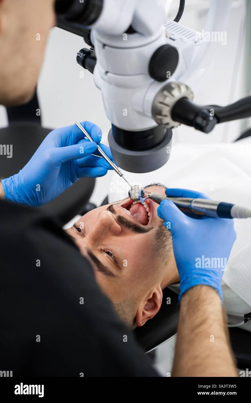 Digital microscope diagnostic by dentist. Polishing teeth with digital ...