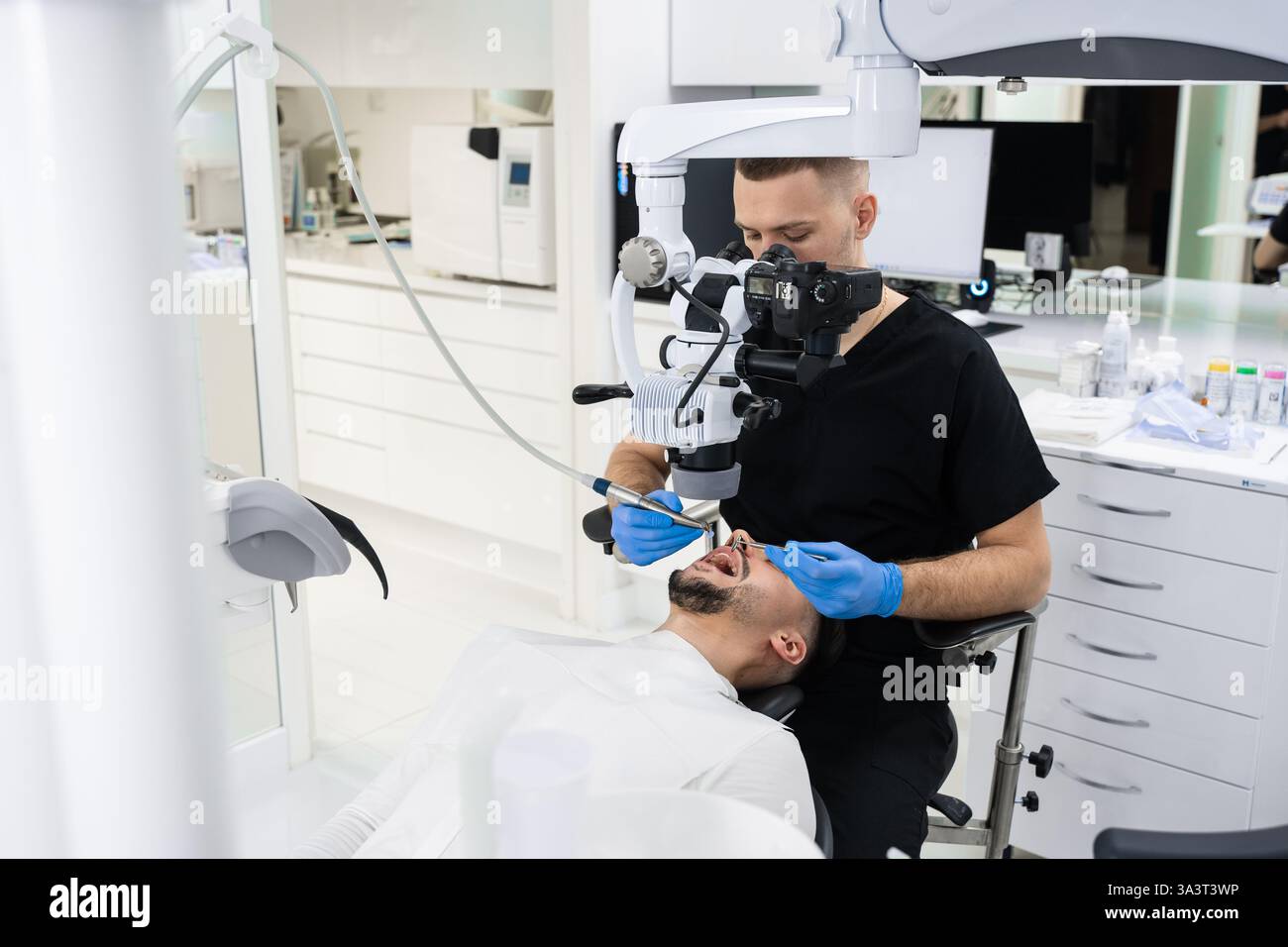 Operating dental digital microscope working process. Dentist uses ...