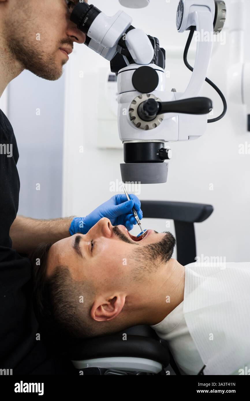 Operating dental digital microscope working process. Dentist uses ...