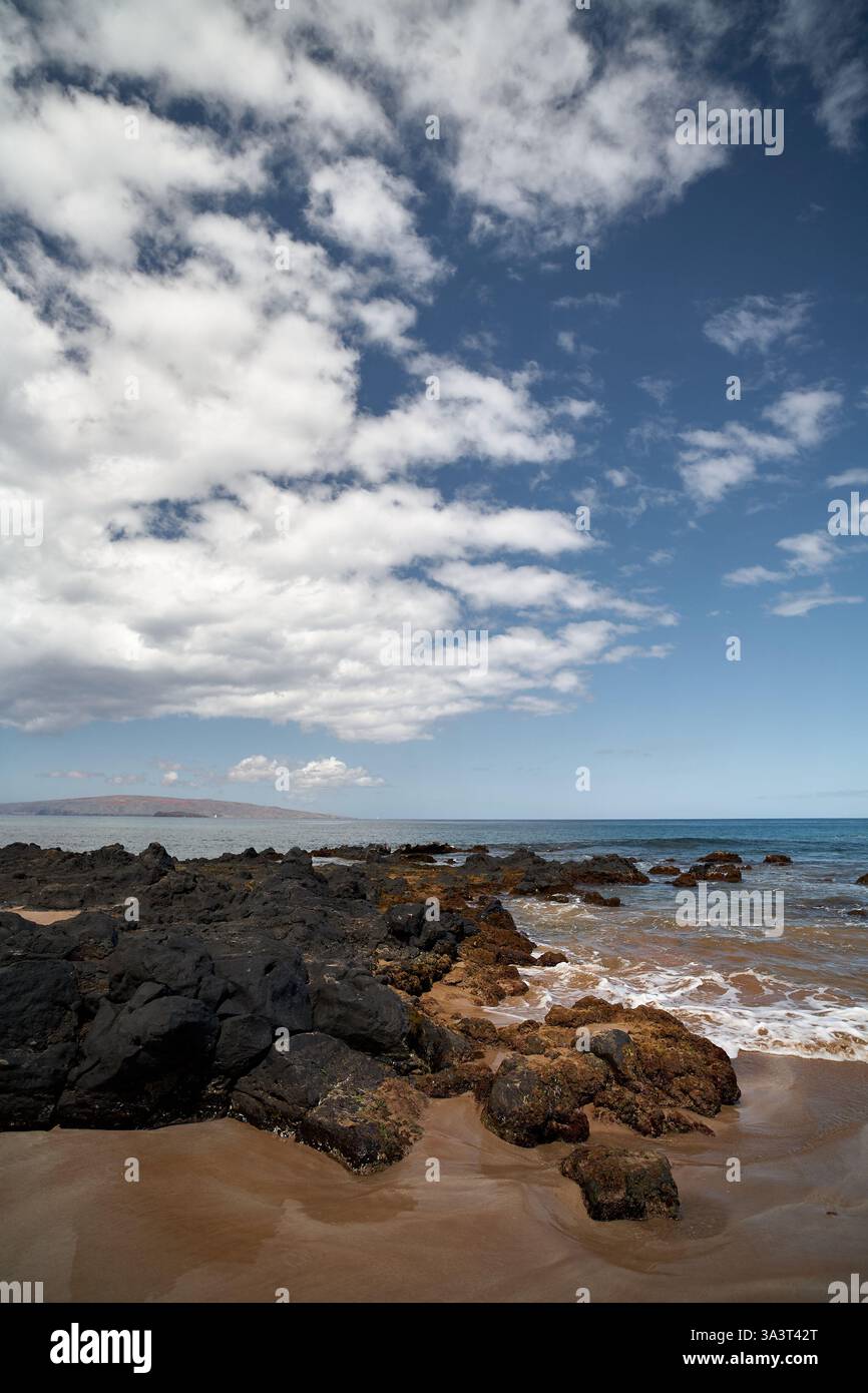 Sandy beach with blue sky and white clouds Stock Photo - Alamy
