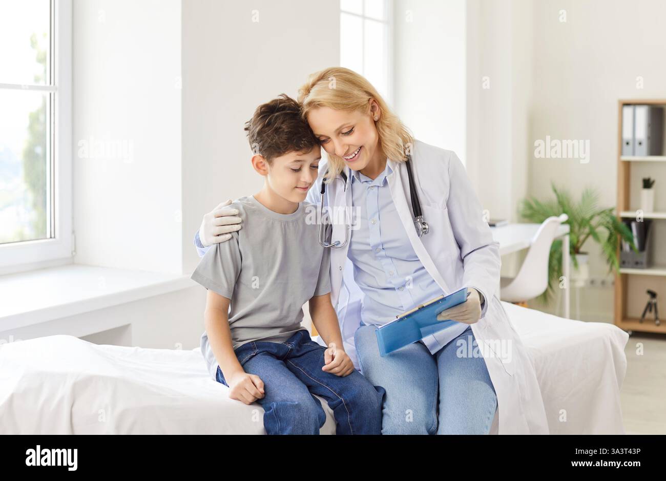 Pediatrician Or Nurse Hugging Happy Schoolboy During Hospital ...
