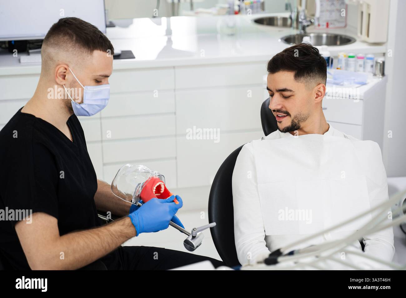 Teeth cleaning technique demonstration by dentist. Doctor teaches ...
