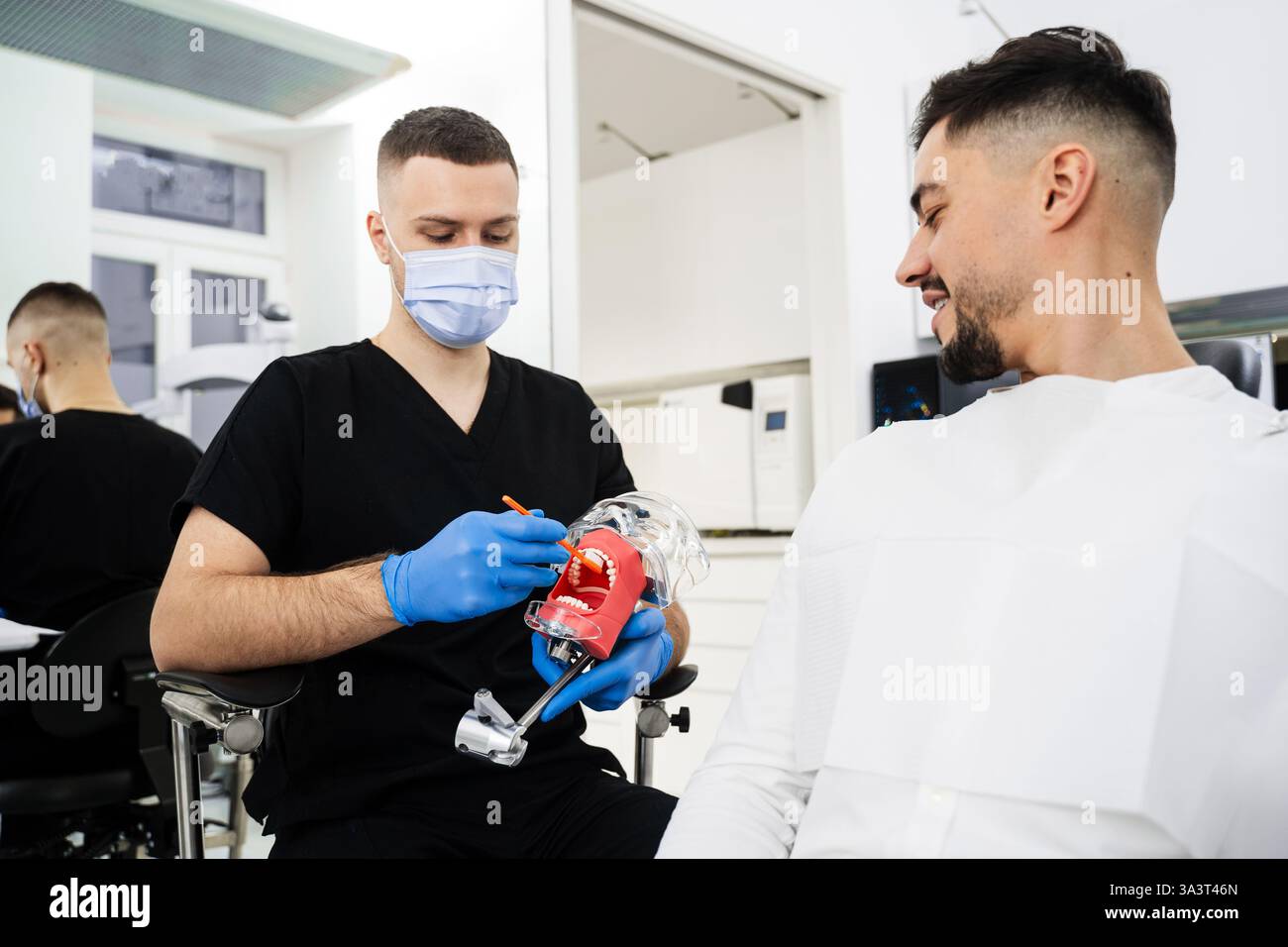 Teeth cleaning technique demonstration by dentist. Doctor teaches ...