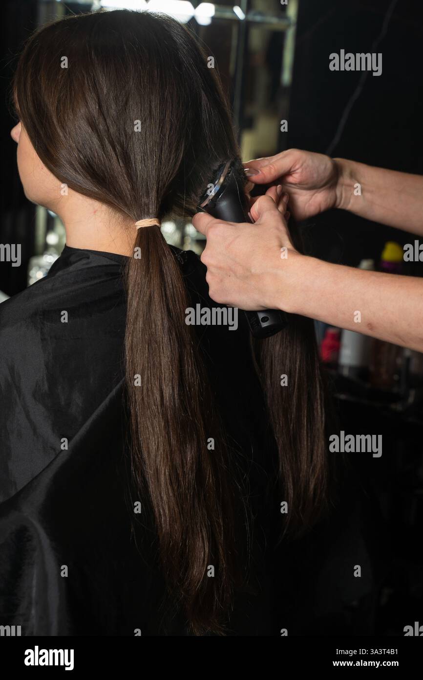 Hair clipper cut for female hairstyles. Hairdresser is making ...