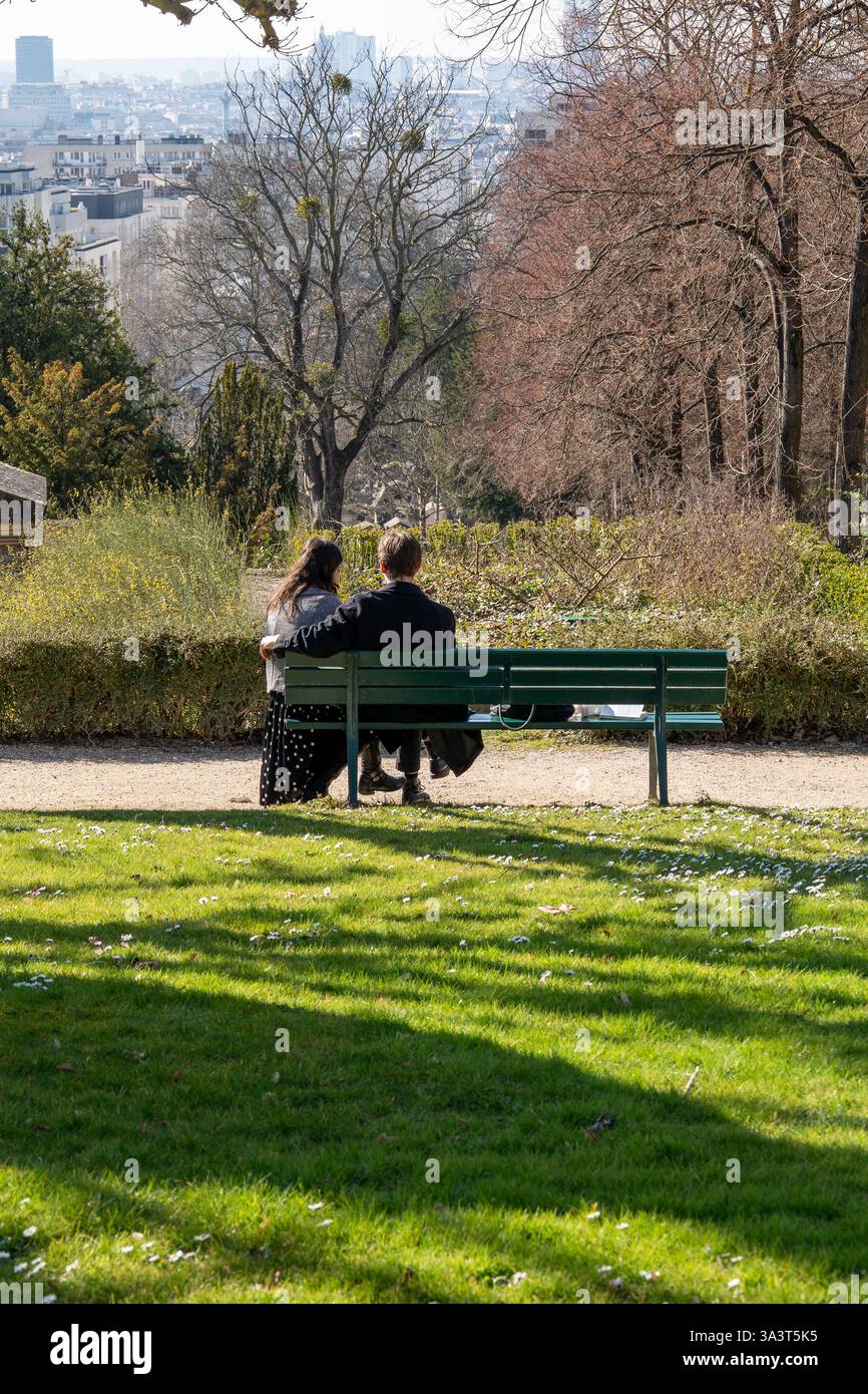 Couple enjoying serene moments on a park bench at Pere Lachaise ...