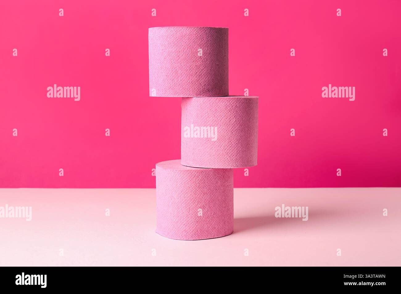 Color toilet paper rolls on pink background Stock Photo - Alamy