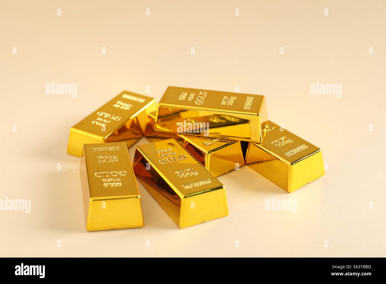 Shiny gold bars on beige background, closeup Stock Photo - Alamy