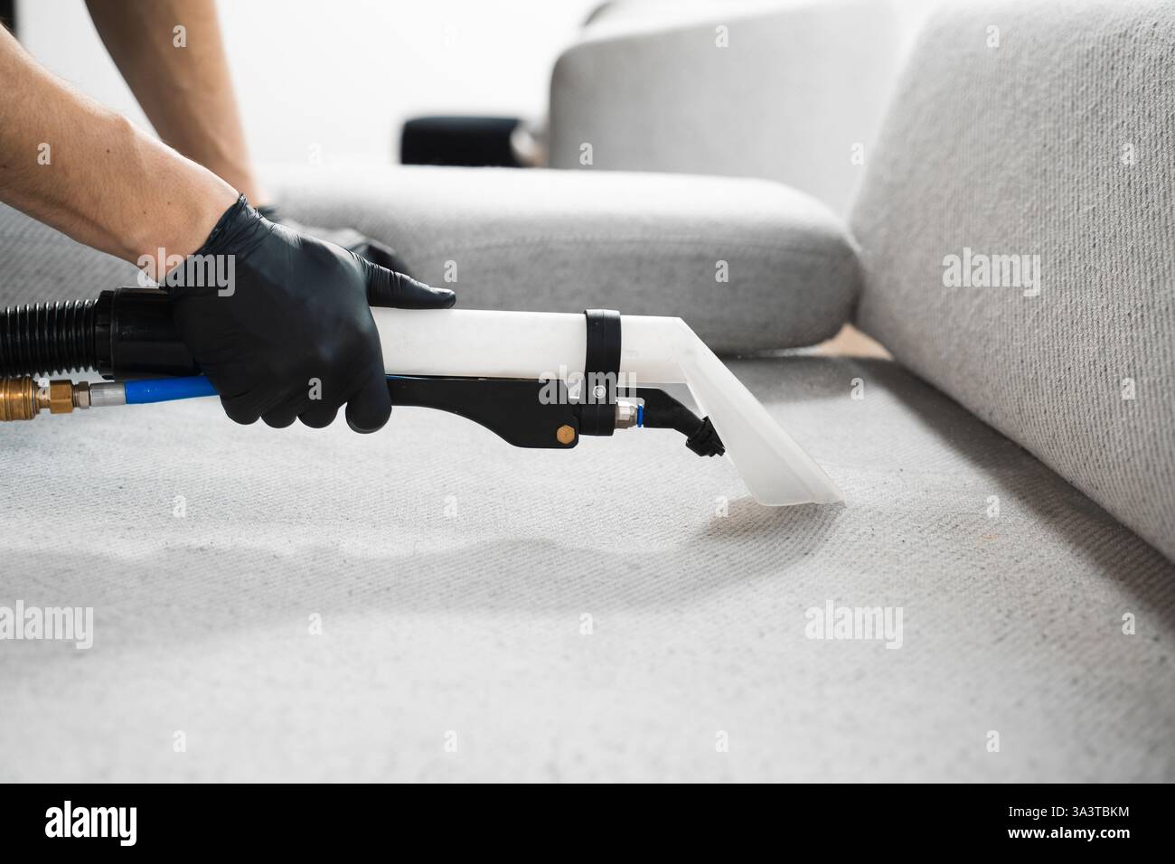 Using extractor to refresh and clean from dust and stains upholstered ...