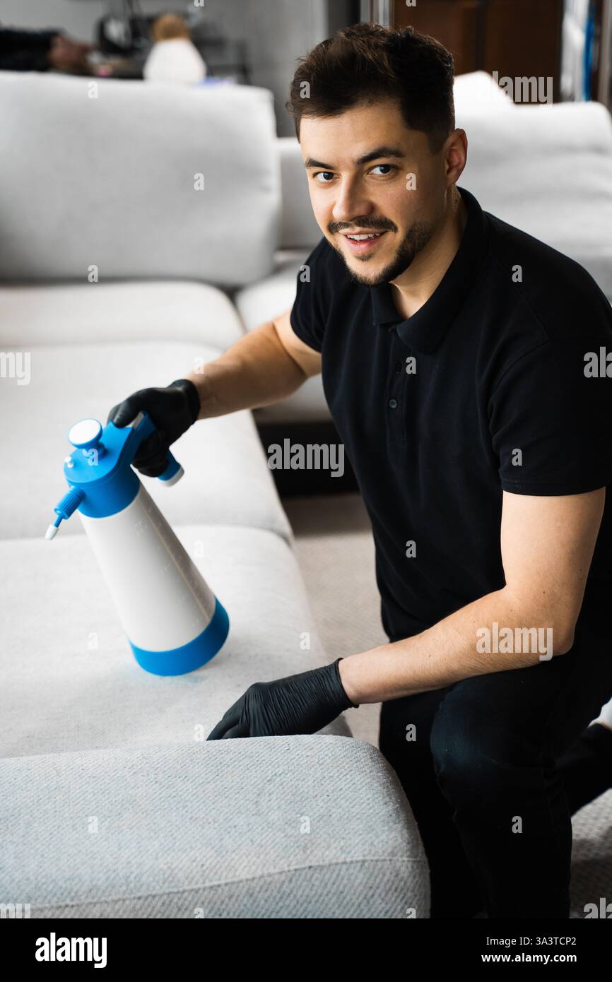 Cleaning furniture at home with spray detergent. Spraying detergent to ...