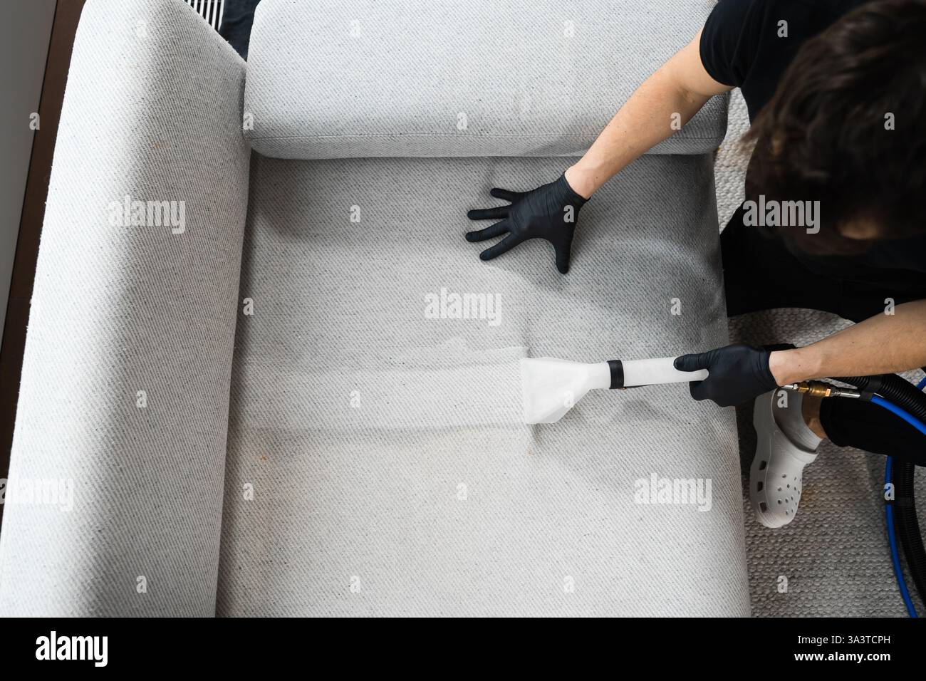 Using extractor to refresh and clean from dust and stains upholstered ...