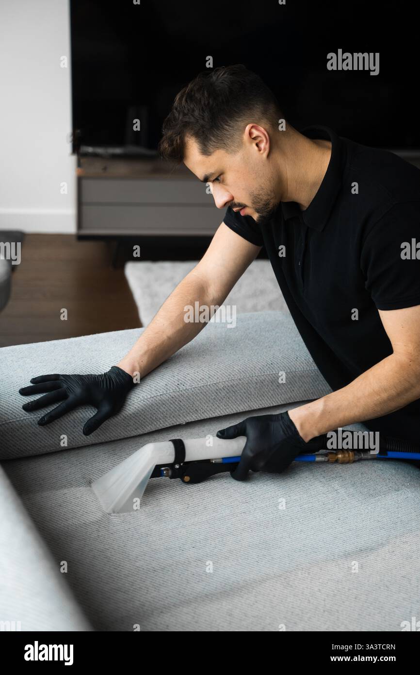 Using extractor to refresh and clean from dust and stains upholstered ...