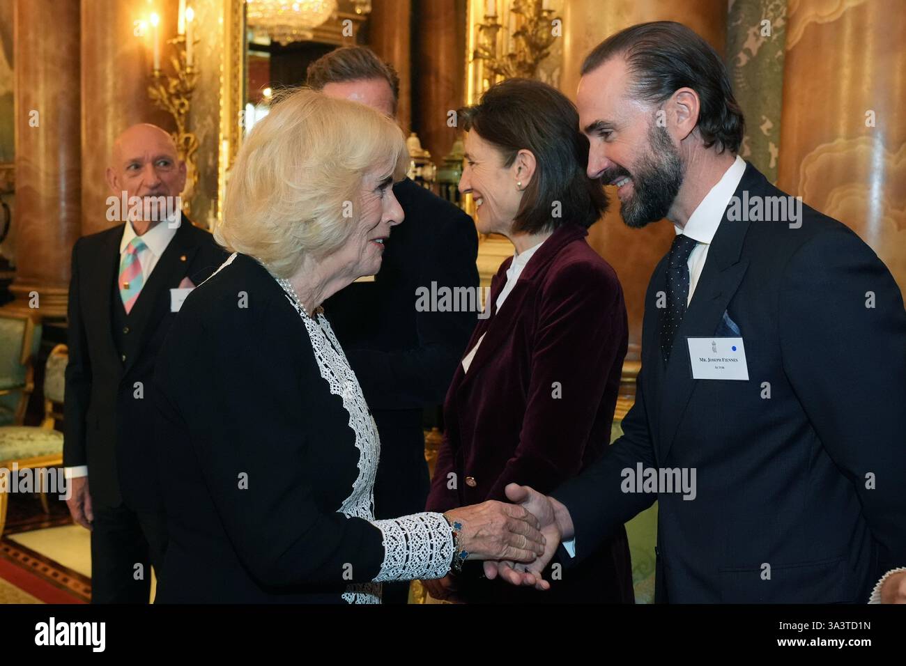 Queen Camilla speaks to Joseph Fiennes during a reception to mark the ...