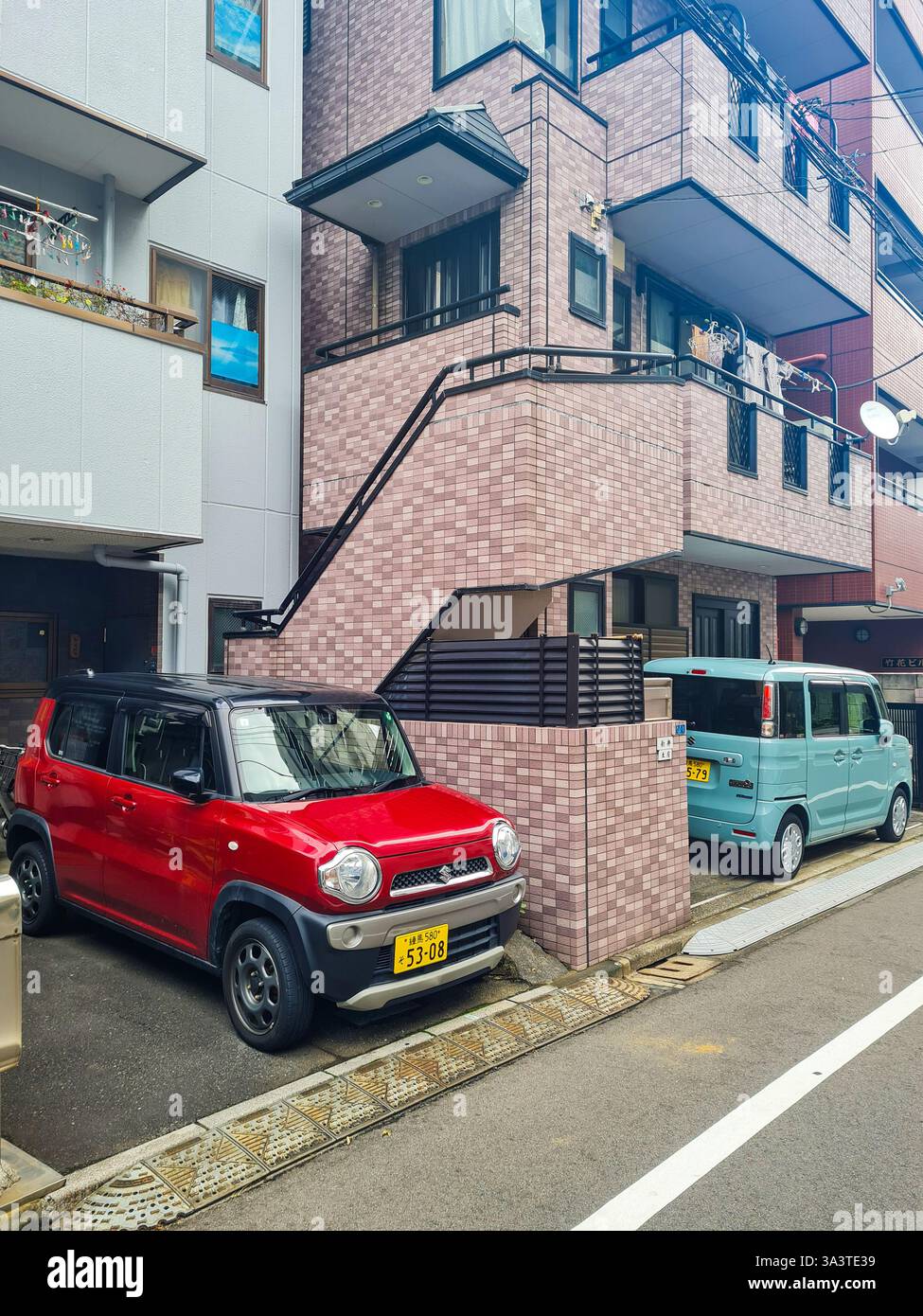 Typical residential street scene in Tokyo with apartment buildings and ...