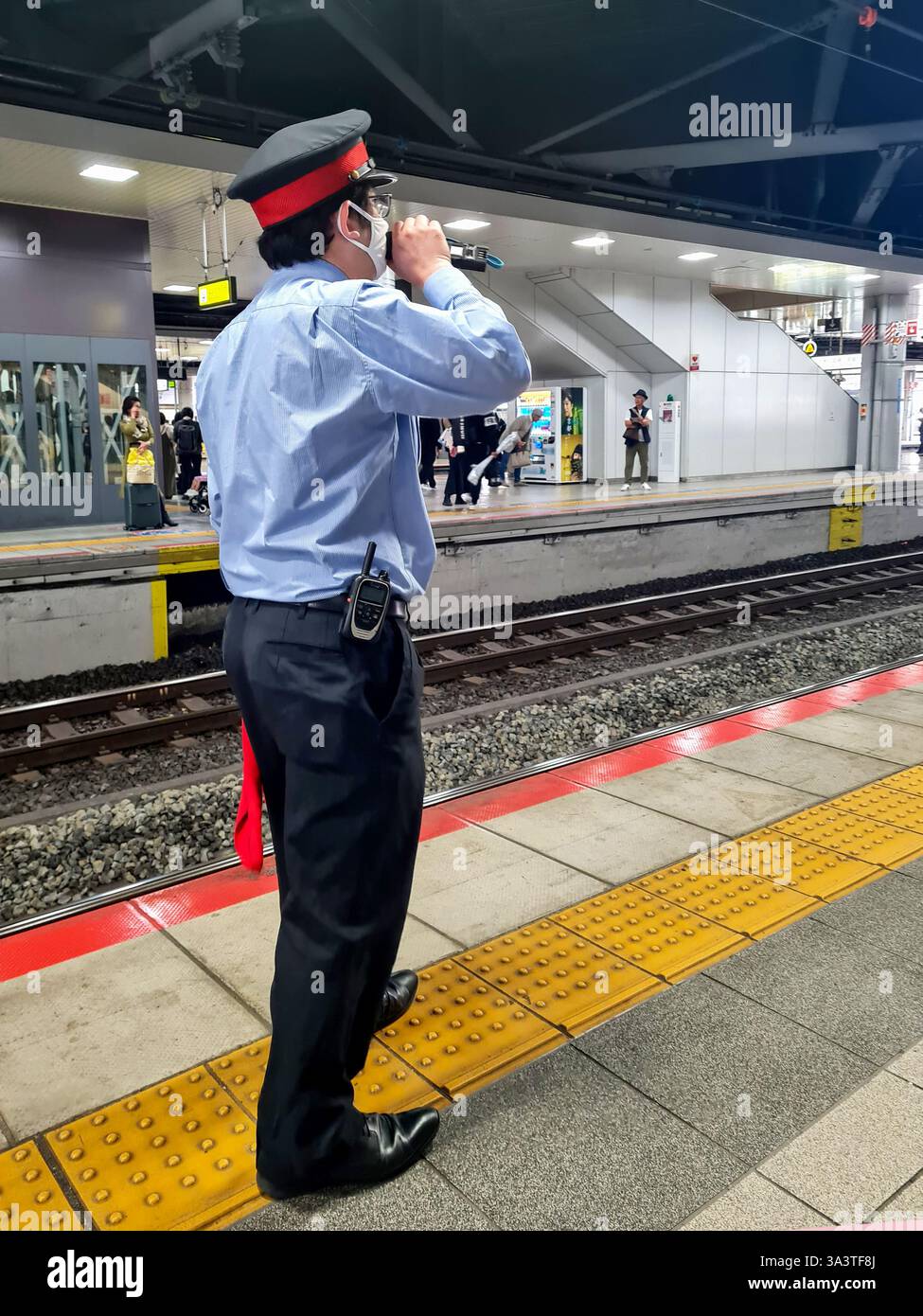 A station platform staff at a train station in Japan Stock Photo - Alamy