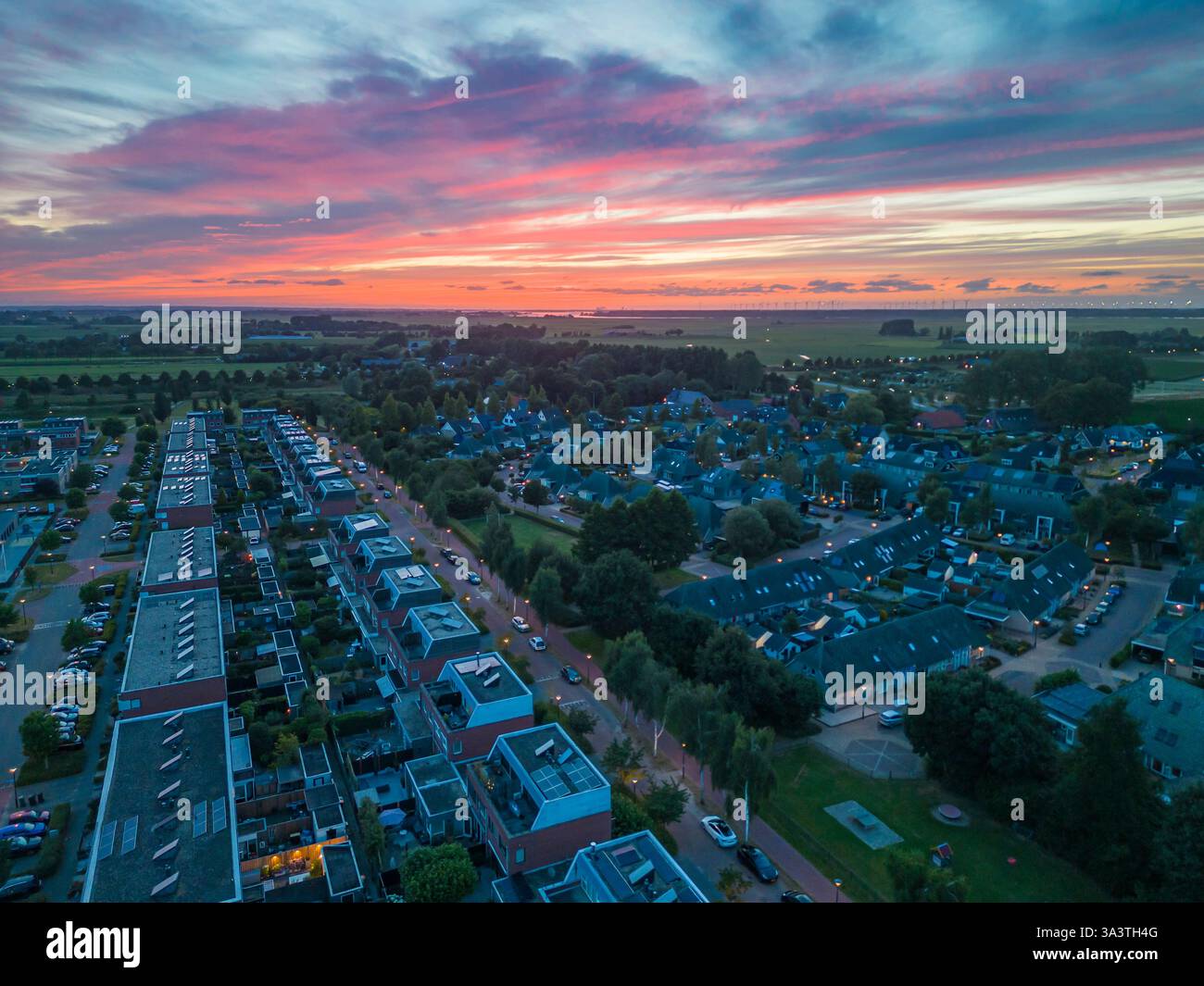 Aerial sunset view of a suburban neighborhood with colorful skies ...