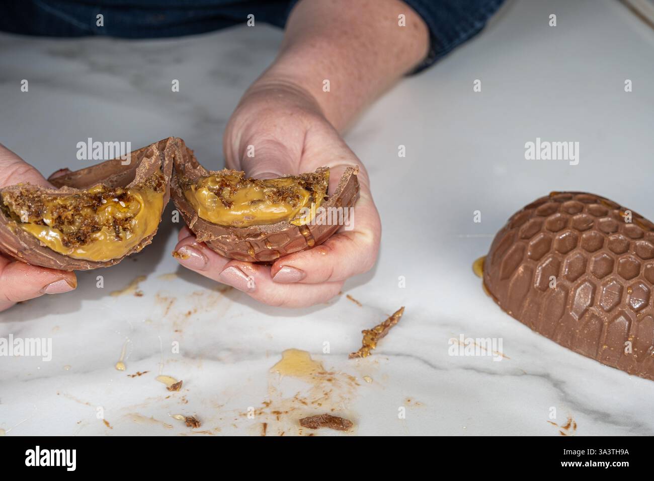 Closeup of Brazilian honey cake filling inside chocolate Easter egg ...
