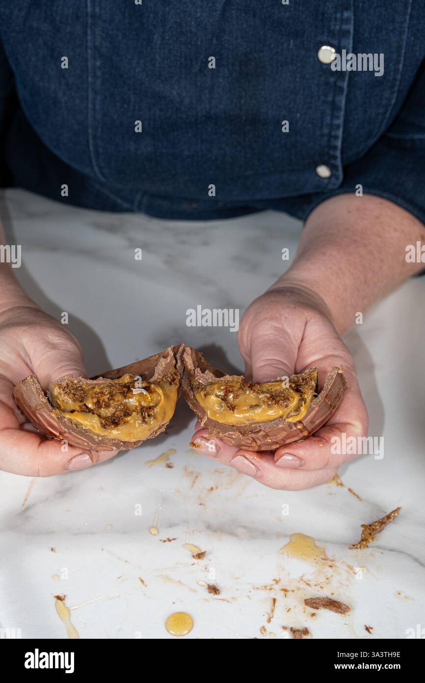 Closeup of Brazilian honey cake filling inside chocolate Easter egg ...