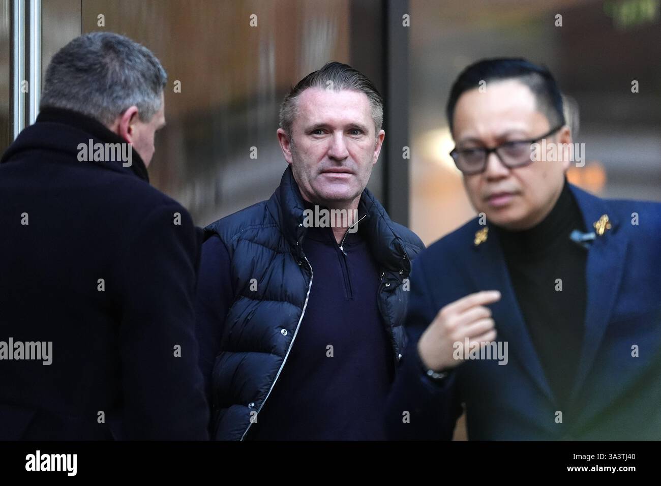 Former Ireland player Robbie Keane (centre) following the Premier ...